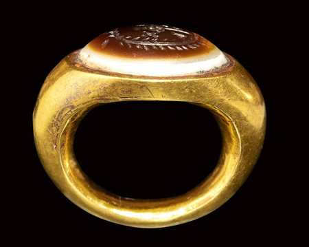 A large banded agate intaglio set in a Sabean gold ring. Emblema with ...