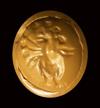 A late roman blue sapphire intaglio set in a gold ring. Peacock. 4th ...