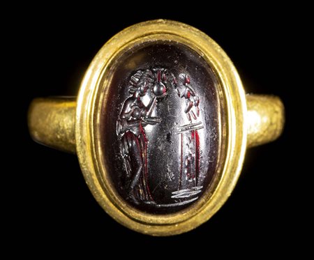 A LARGE ROMAN GARNET CABOCHON INTAGLIO SET IN A MODERN GOLD RING ...